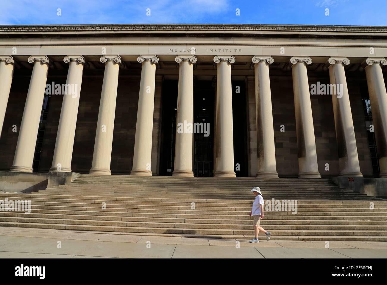 A woman walking pass the Mellon Institute.Carnegie-Mellon University ...