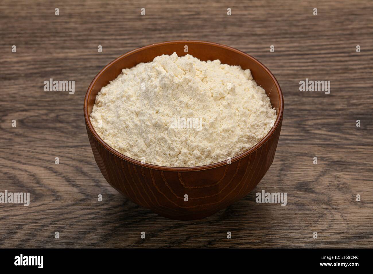 Wheat flour heap in the bowl for cooking Stock Photo - Alamy