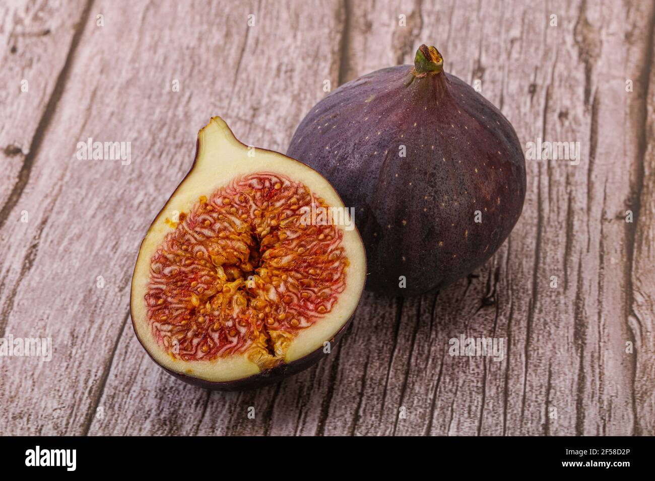 Sweet purple slice of fig fruit Stock Photo - Alamy