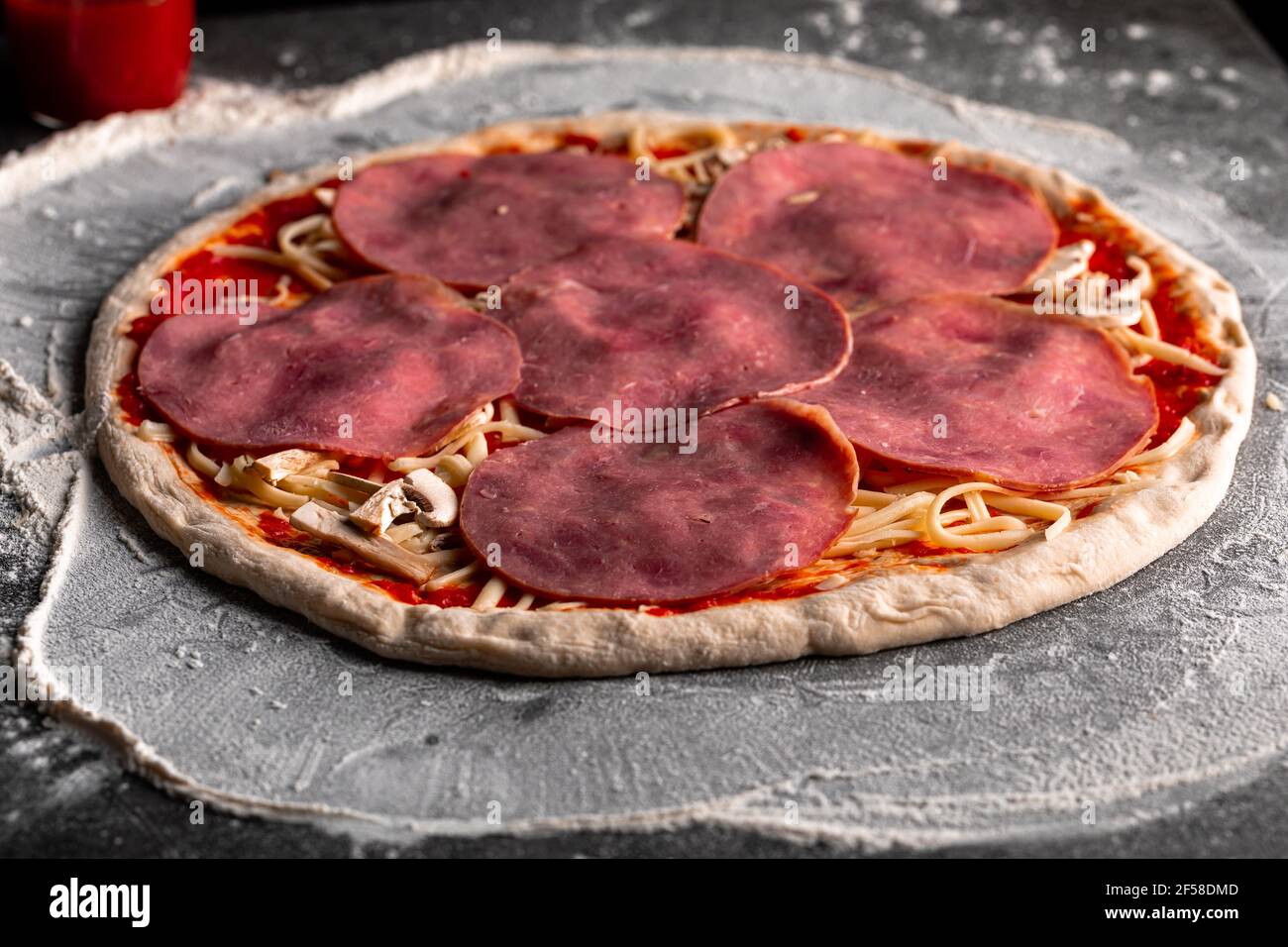 Prepared dough base for pizza with toppings Stock Photo - Alamy