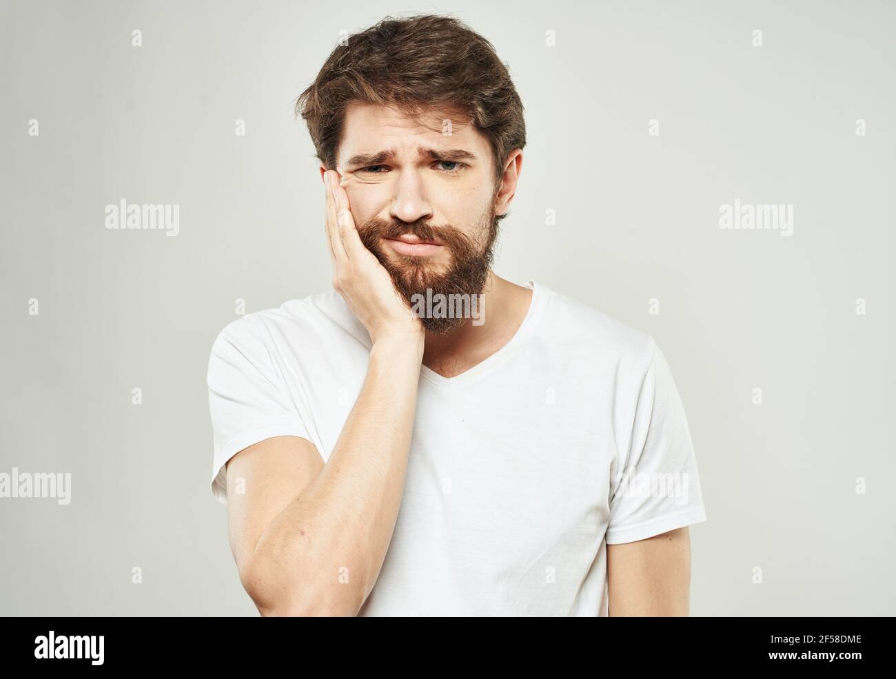 Sad guy with bushy beard gestures with his hands Copy Space cropped ...