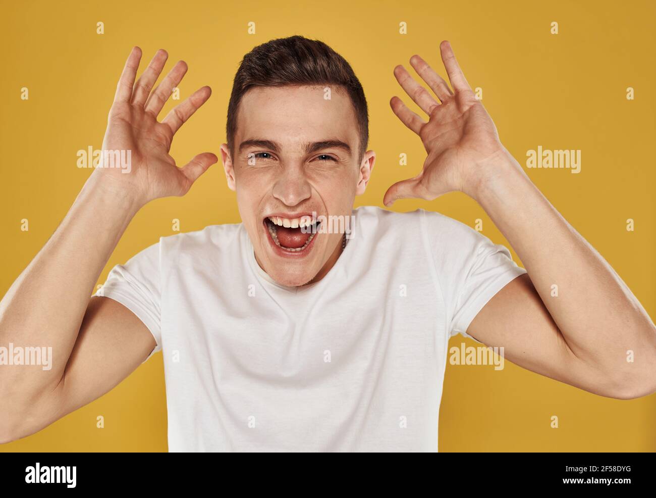 Man laughs on a yellow background Delight emotions joy Stock Photo - Alamy