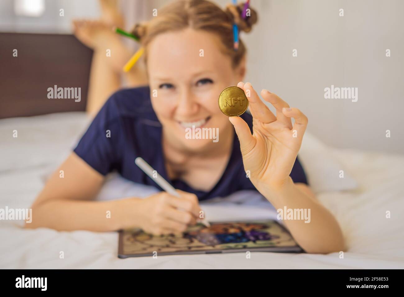 NFT Young woman, a digital artist, creates digital art on a tablet at ...