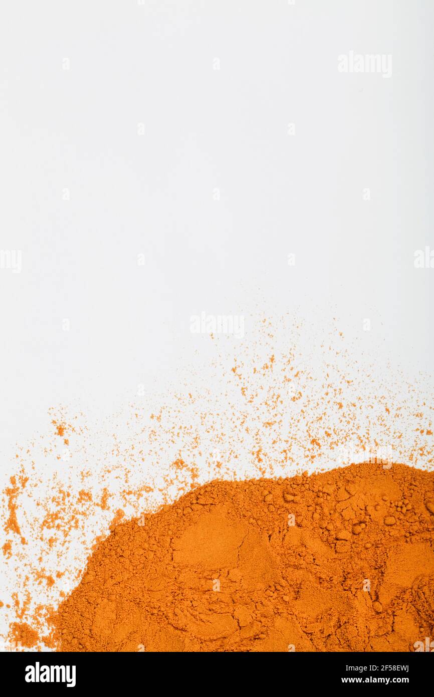 yellow curcuma or turmeric powder on white background. top view. copy ...