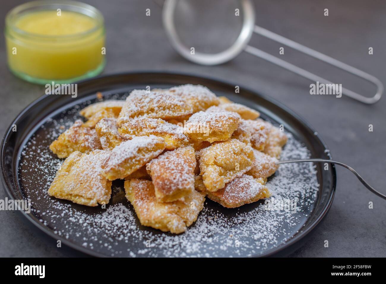 Austrian cuisine. Torn pancake (or omelet) kaiserschmarrn with honey ...