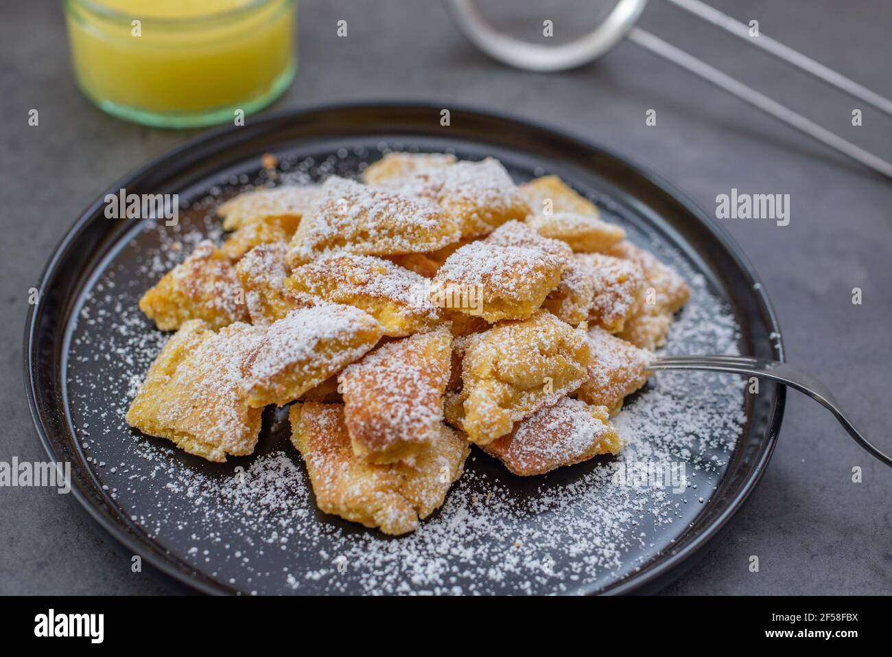 Austrian cuisine. Torn pancake (or omelet) kaiserschmarrn with honey ...