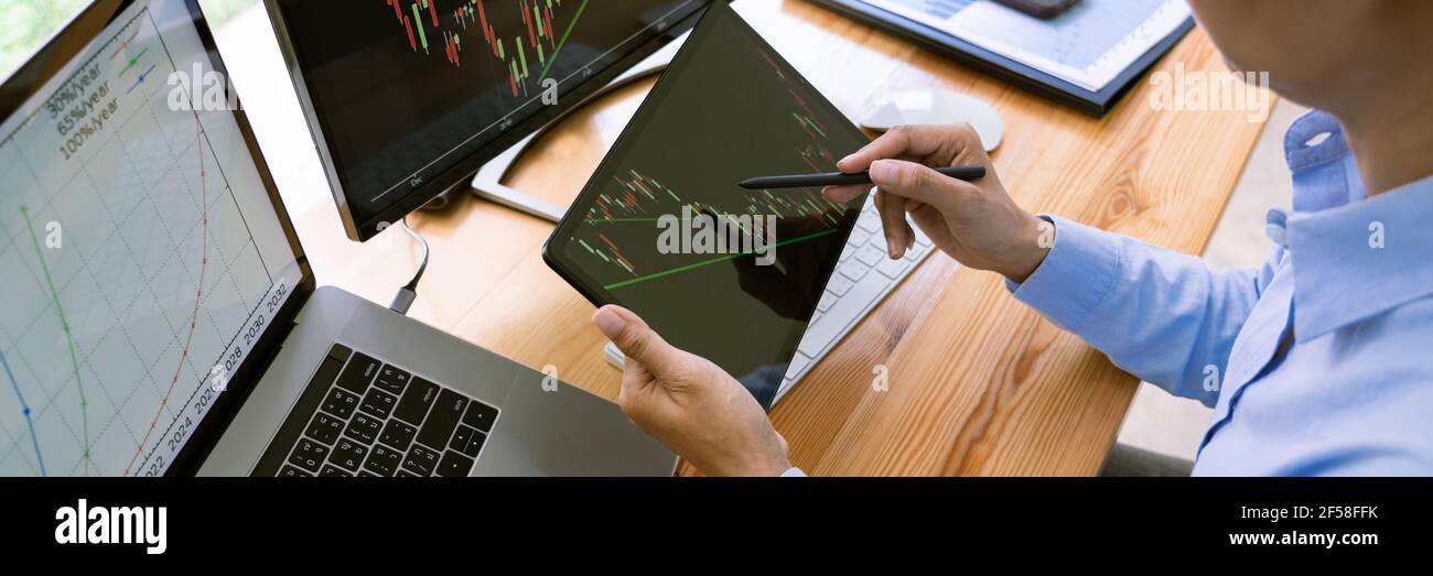 Stock Market Broker in formalwear Analyzing Graphs on screens in the ...