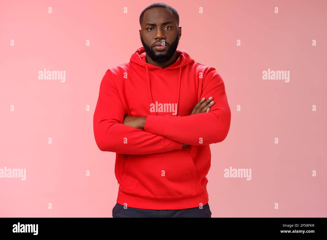 Serious-looking strong black guy security worker cross hands chest ...