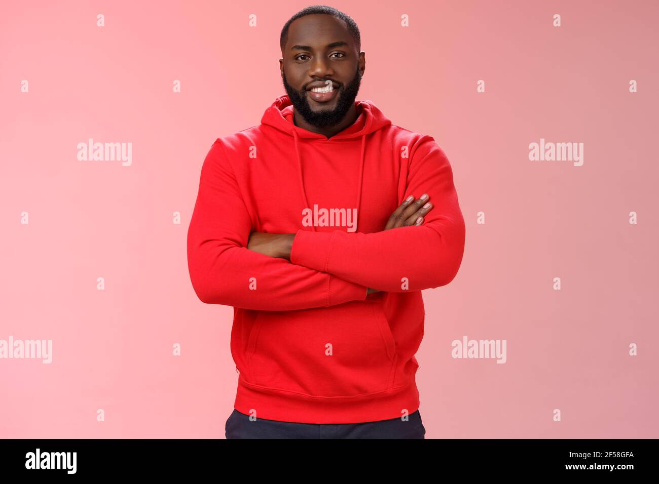 Attractive bearded african-american young guy wearing red hoodie cross ...