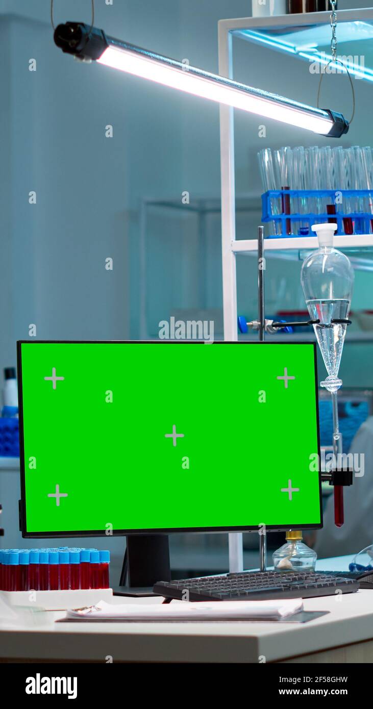 Team of scientists working in background of modern laboratory using ...