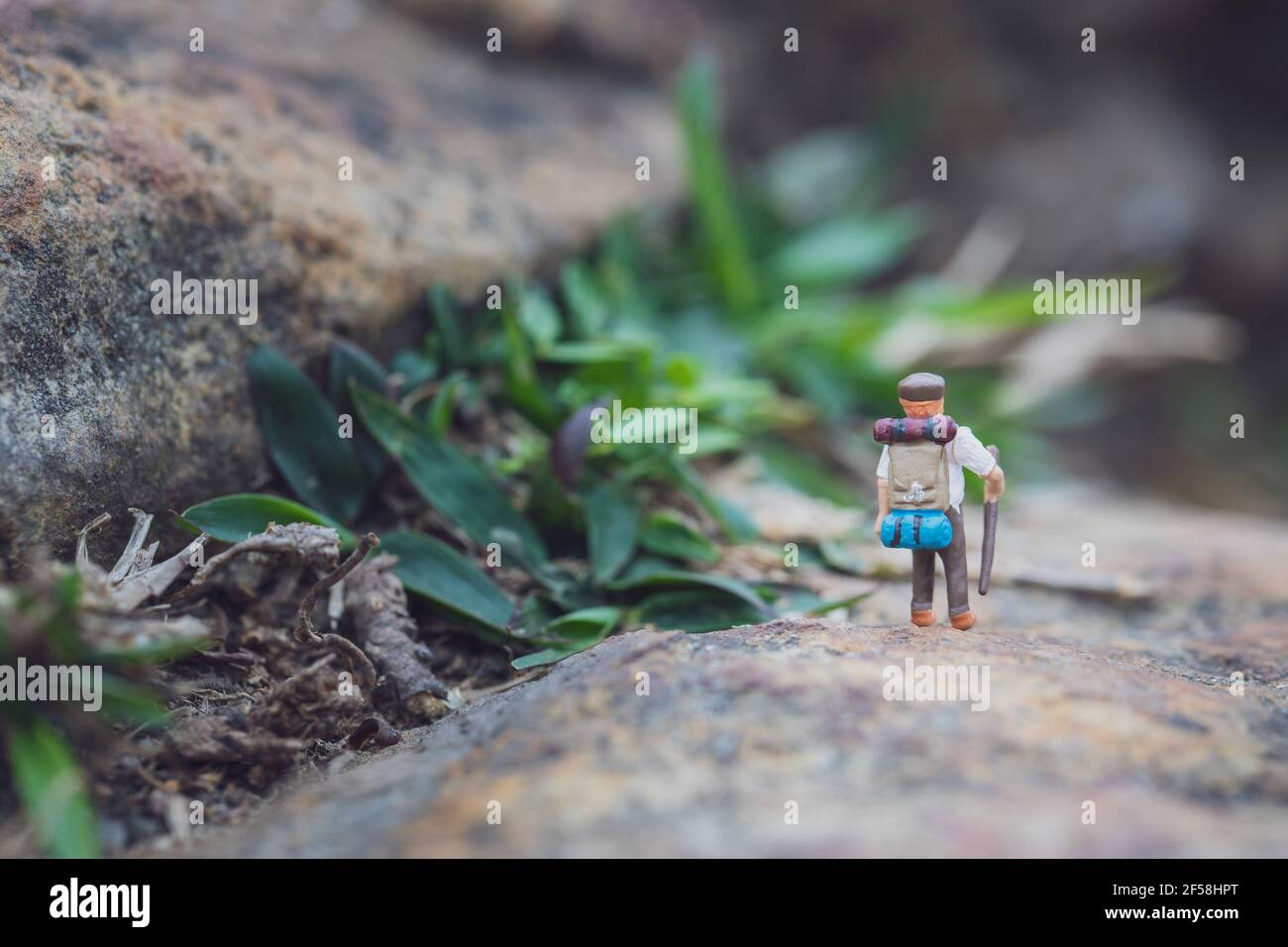 Fun concept of miniature hiker figure adventure in the rocks, outdoor ...