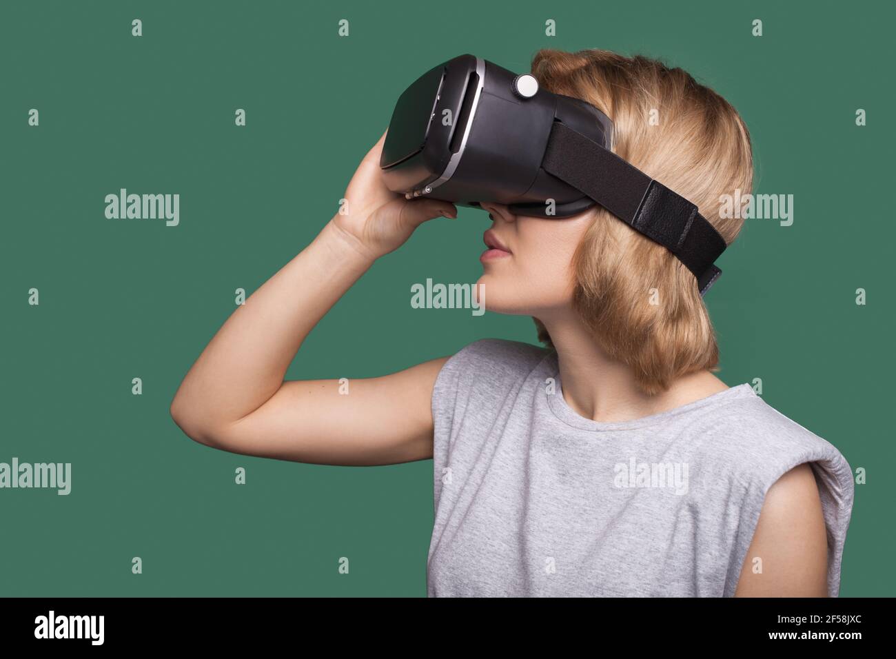Side view photo of a caucasian woman with blonde hair trying new vr ...
