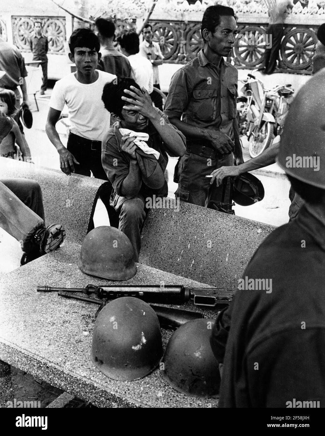 1975-04-15 A crying junta soldier at a funeral. His commanding officer ...