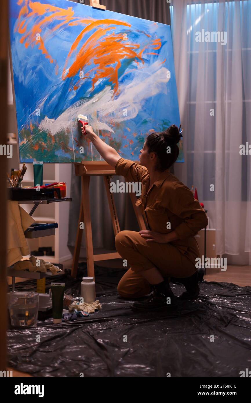 Famous woman artist working on impressionism painting in art workshop ...