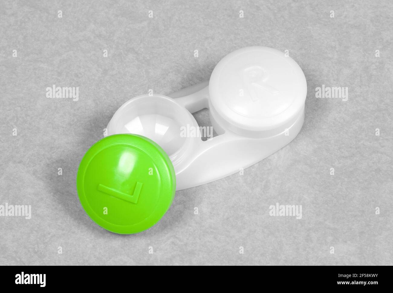 Green contact lens case, isolated on grey background Stock Photo - Alamy