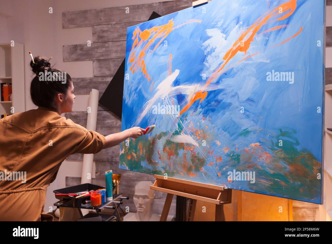 Successful artist painting in art workshop with innovative imagination ...