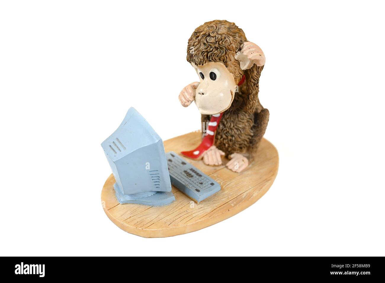 Monkey at the computer, statuette on an isolated background . High ...