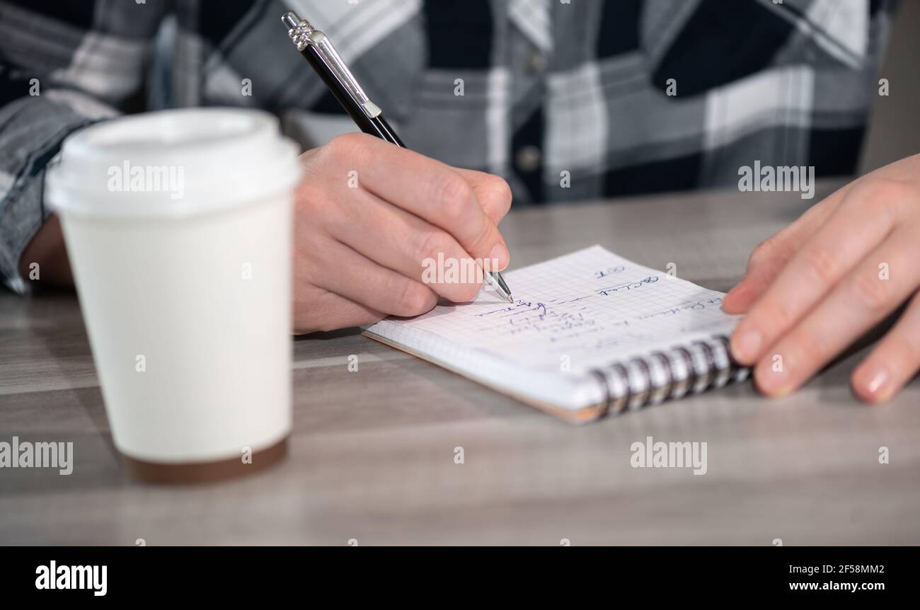 Female hands taking notes on notepad Stock Photo - Alamy