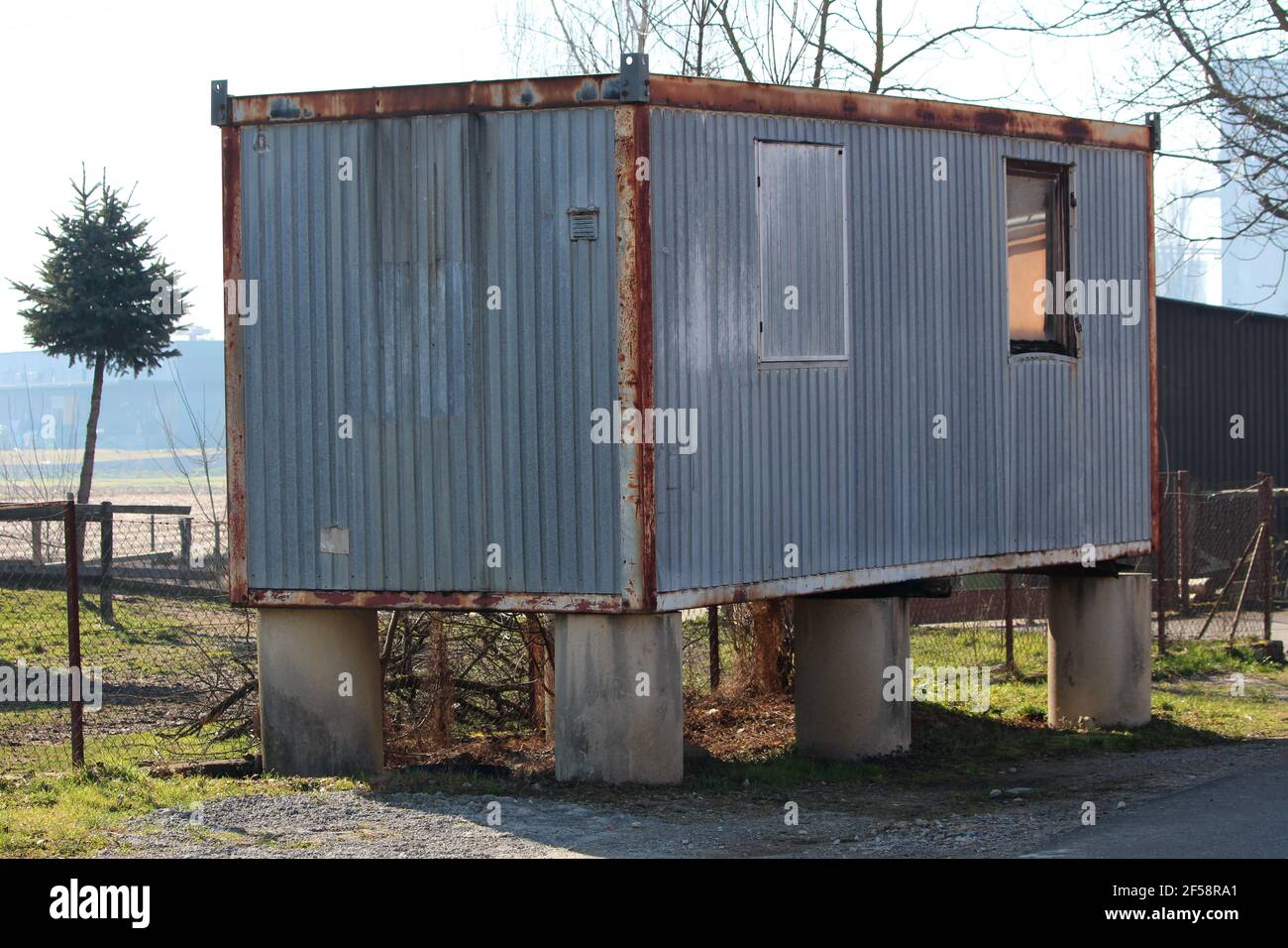 Dilapidated partially rusted metal shipping container converted into ...