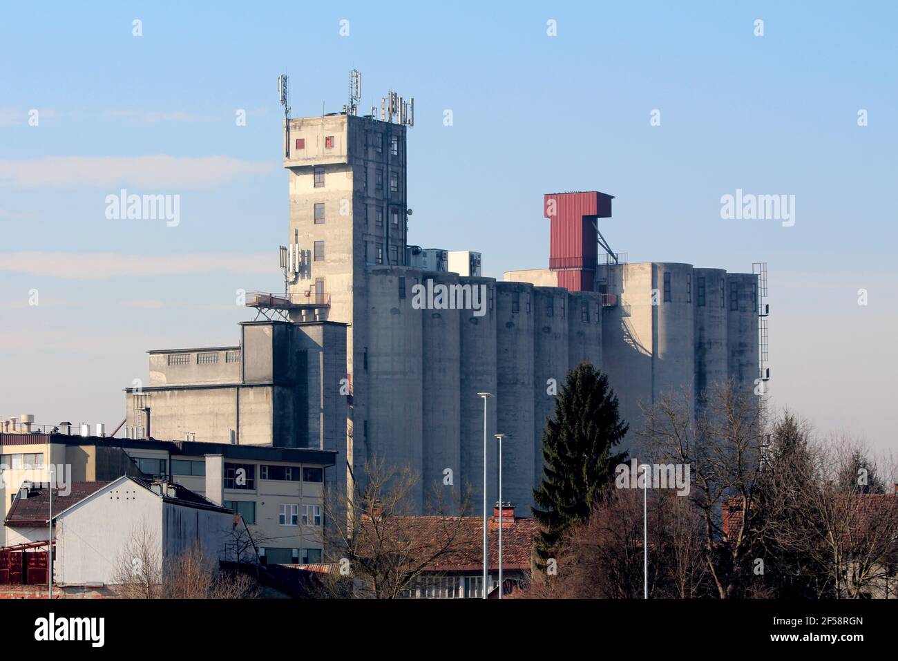 Large dilapidated industrial complex concrete storage silos with ...