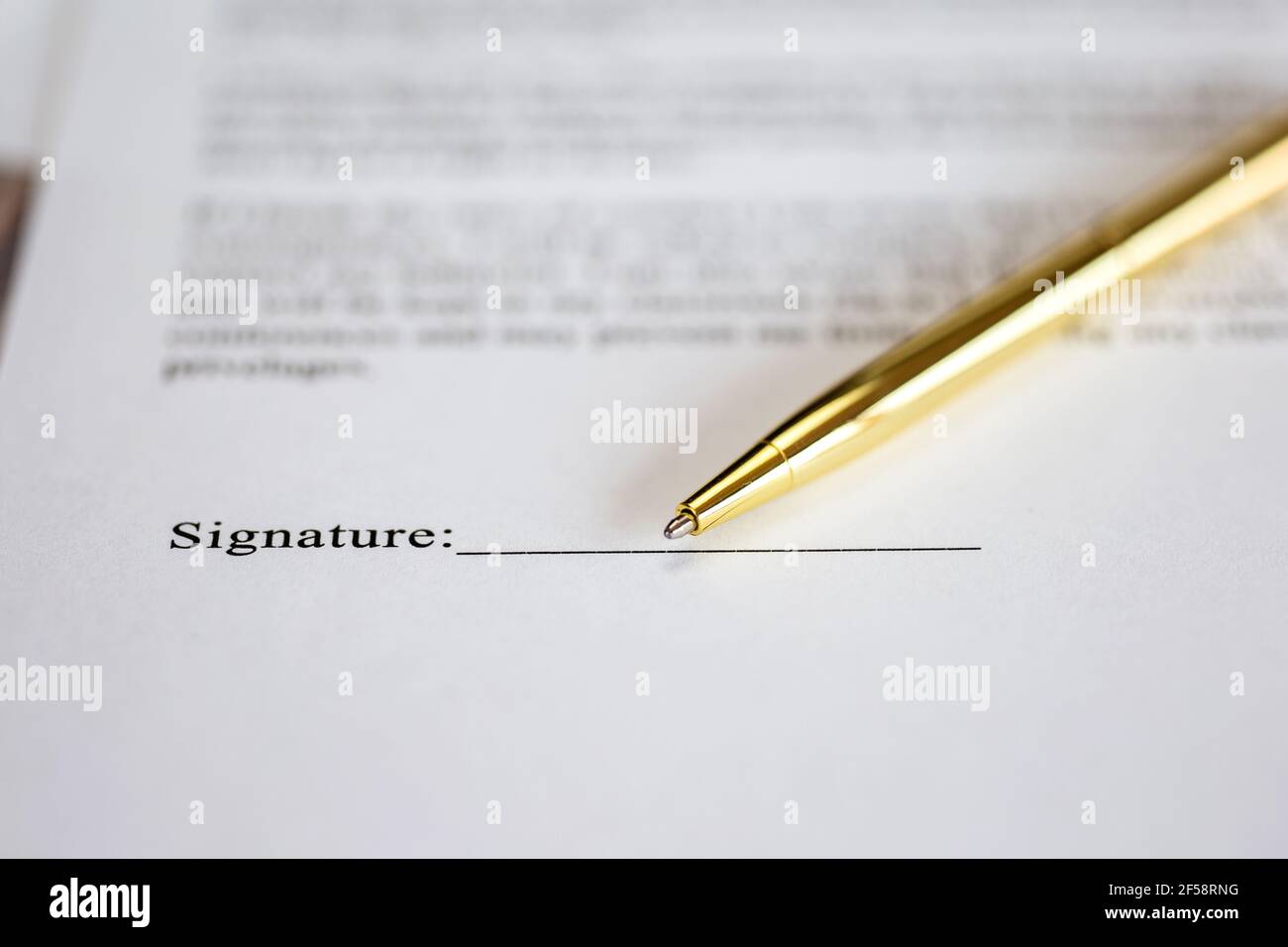 Signing a contract with signature with gold pen macro close-up ...