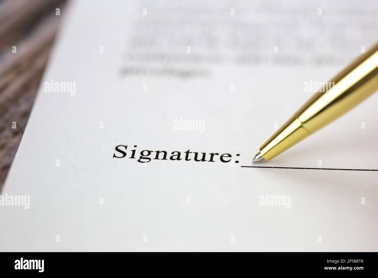Signing a contract with signature with gold pen macro close-up ...