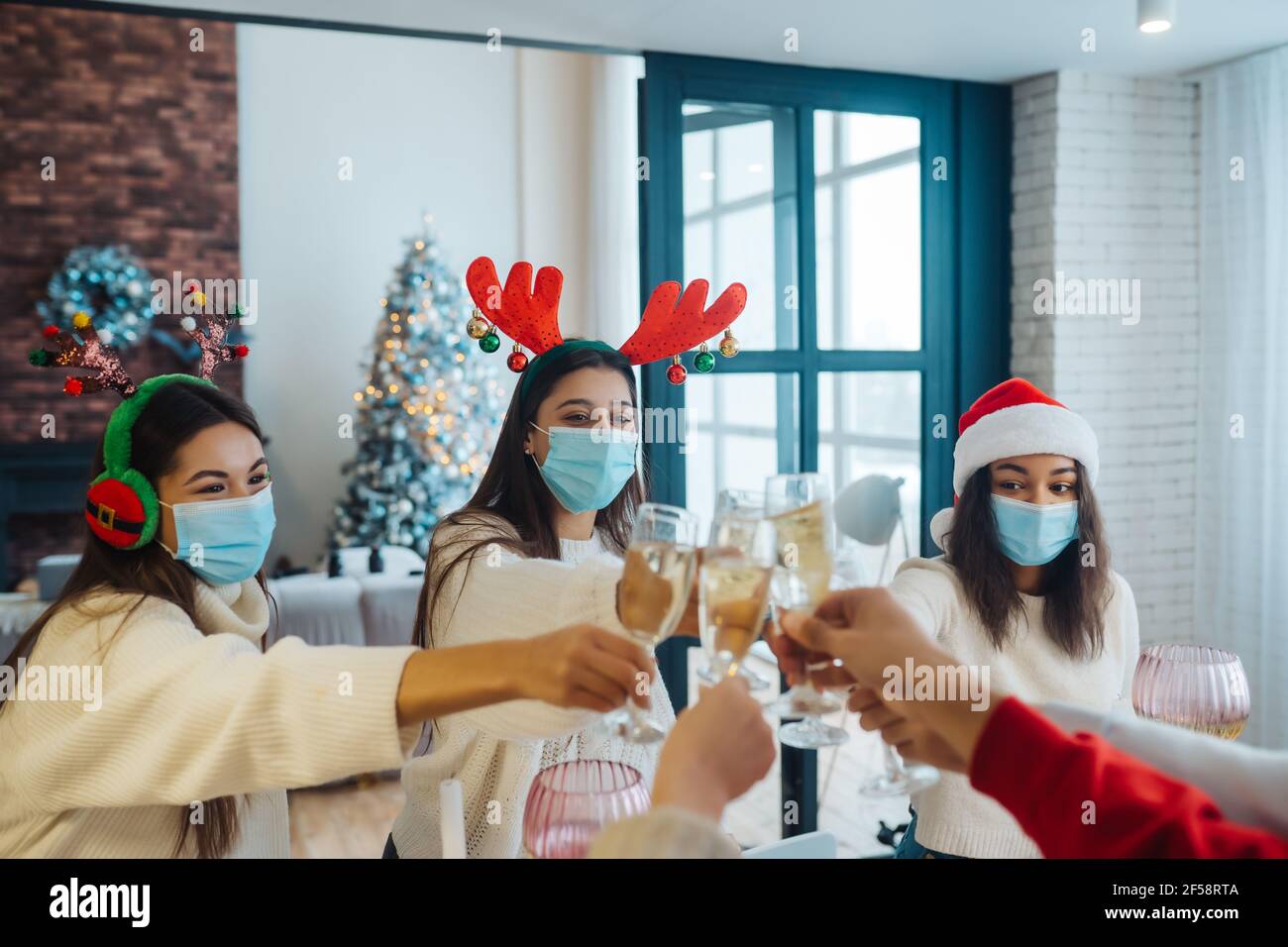 Multi-ethnic young people celebrating New year eve at party Stock Photo ...