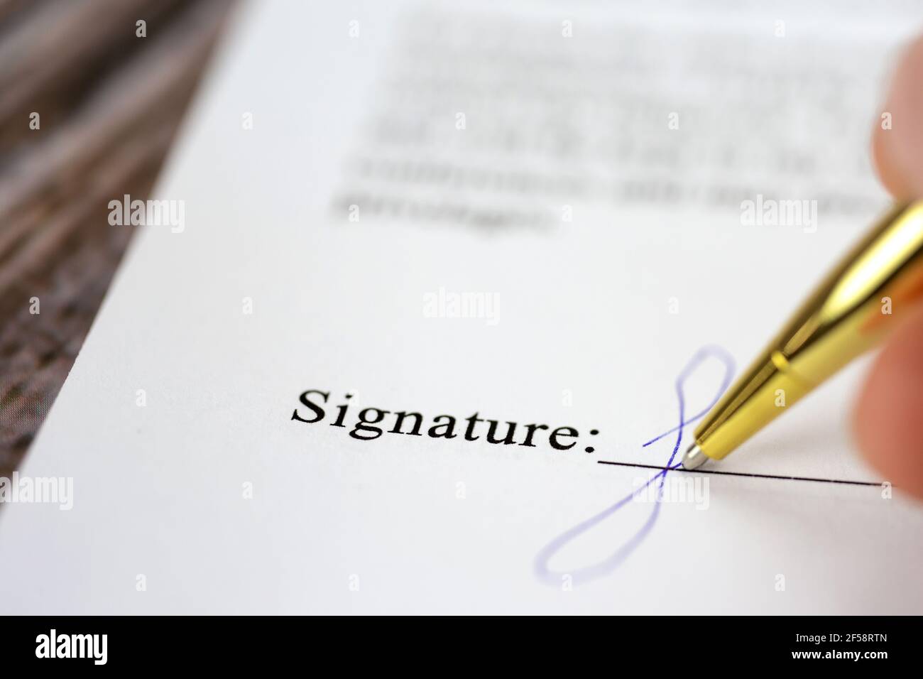 Signing a contract with signature with gold pen macro close-up ...