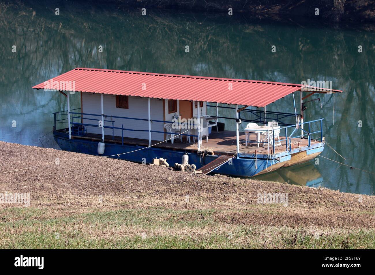 Side view of river barge converted into river boat house with ...