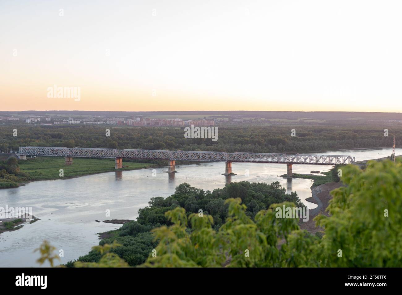 Railway bridge over Belaya river on morning sunrise sky. Sunset over ...