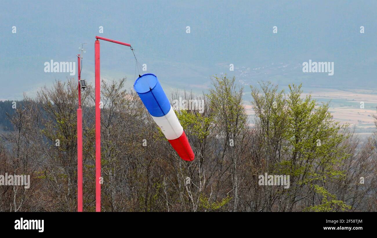 wind sock - red , blue and white pointer indicating strength and ...