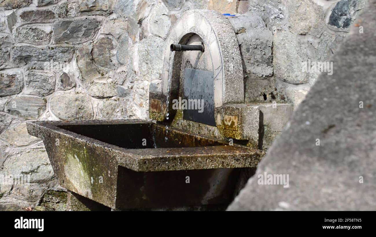 Clear and cold water flowing from metal pipe, fountain, waterplace ...