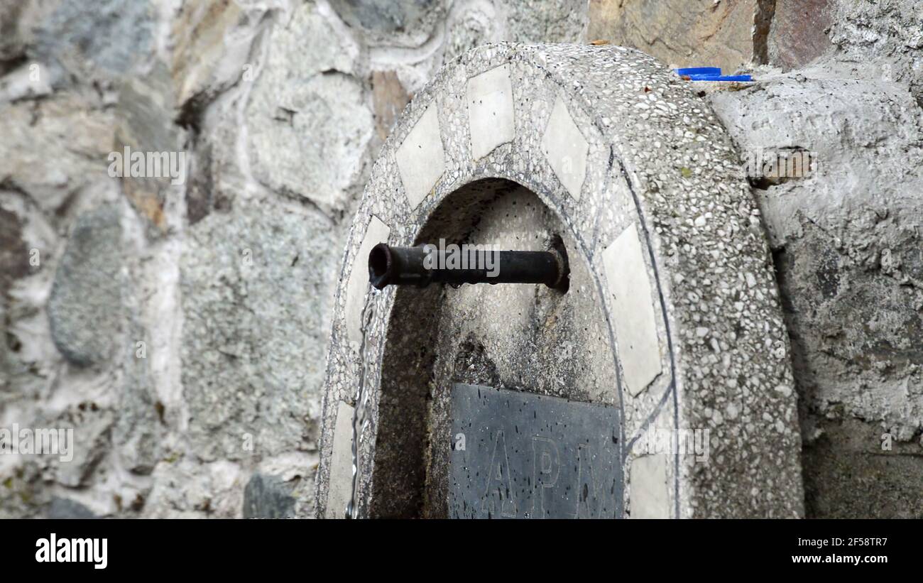 Clear and cold water flowing from metal pipe, fountain, waterplace ...