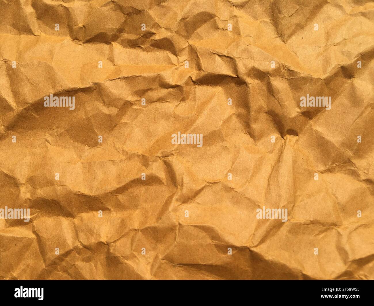 Old brown crumpled paper background with copy space for Design. Closeup ...