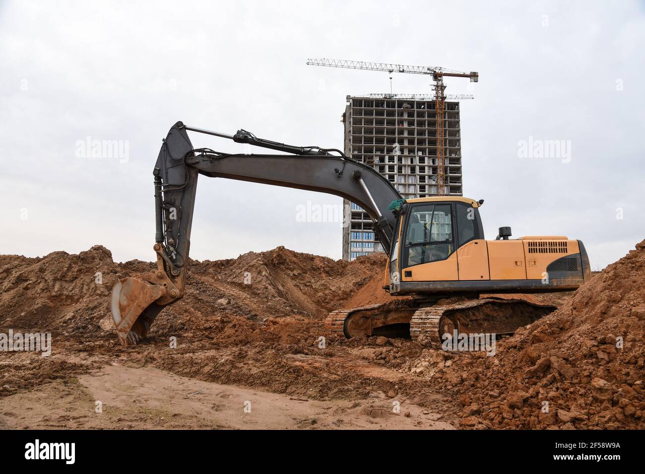 Excavator during excavation at construction site. Backhoe on Earthworks ...