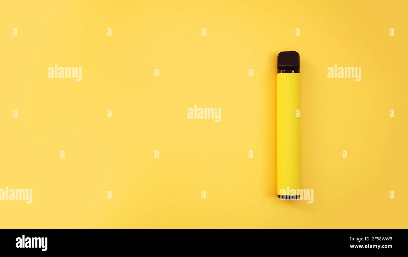 Yellow disposable electronic cigarette on bright yellow background ...