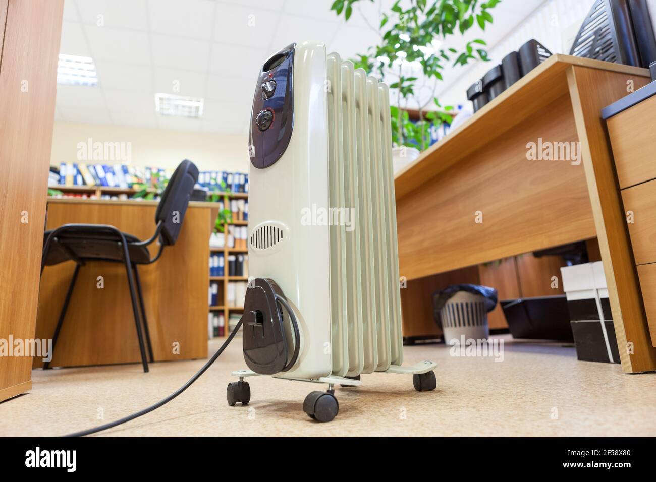 Oil filled radiator used in an office, standing in center of the room ...