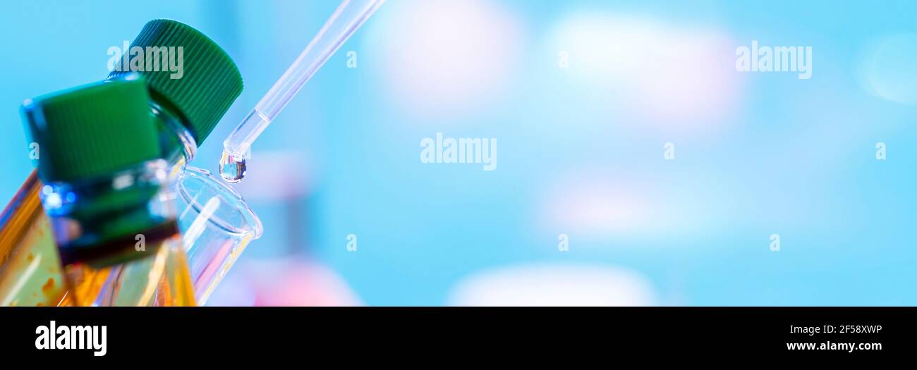 Chemical test tube and pipette with a drop of colorless liquid and two ...