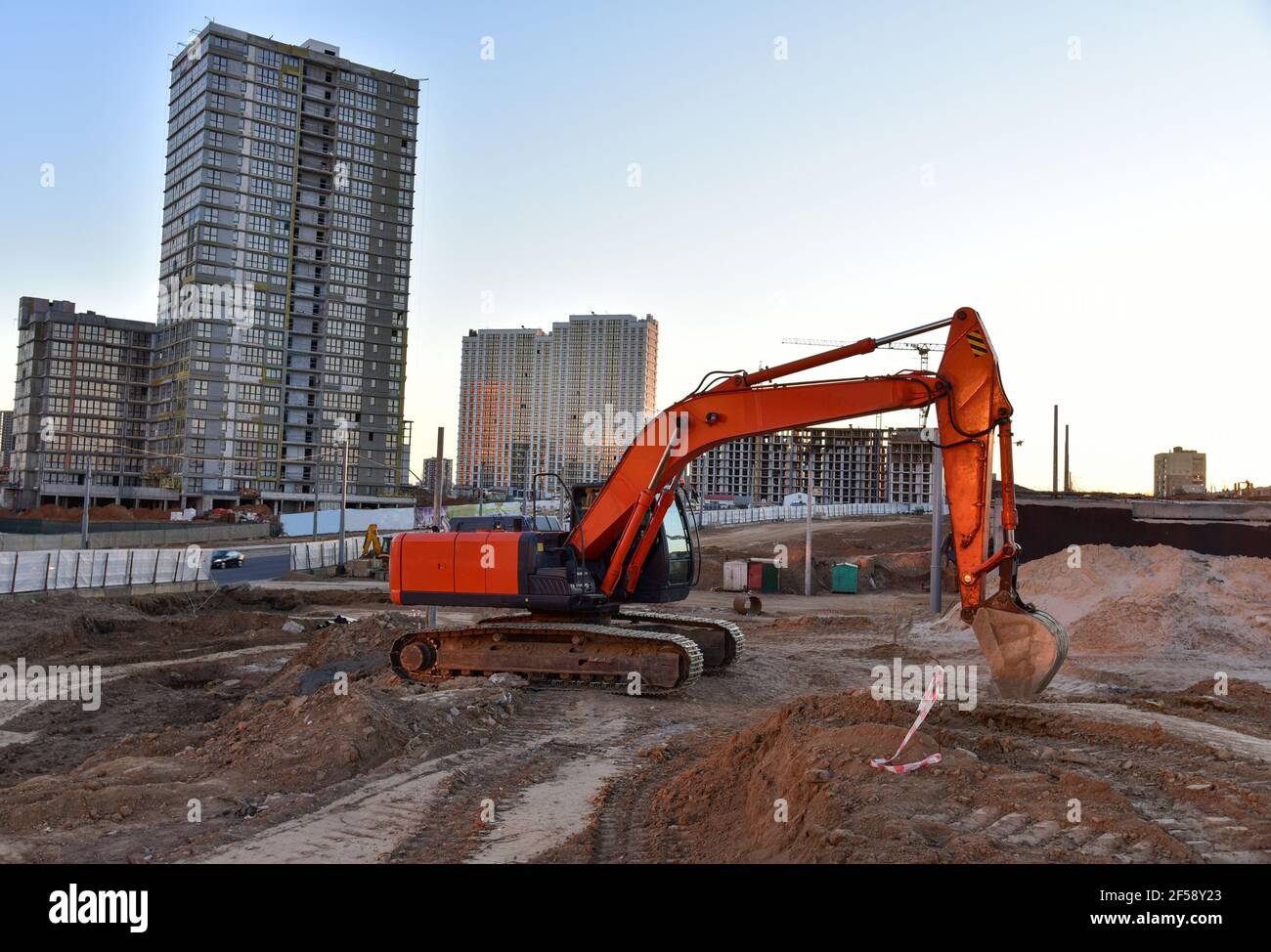 Excavator during excavation at construction site. Backhoe on road work ...