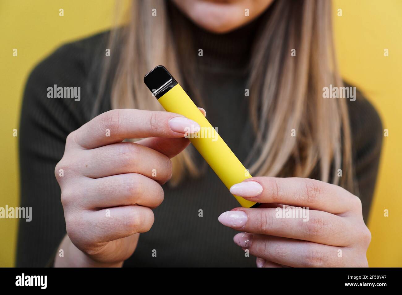 Young woman smoking electronic cigarette hi-res stock photography and ...