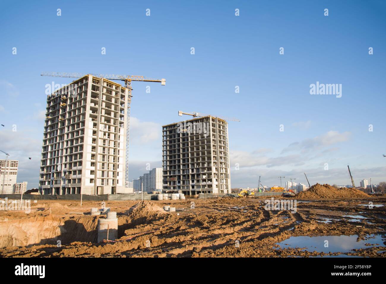 Tower cranes constructing a new residential build. Pouring concrete ...