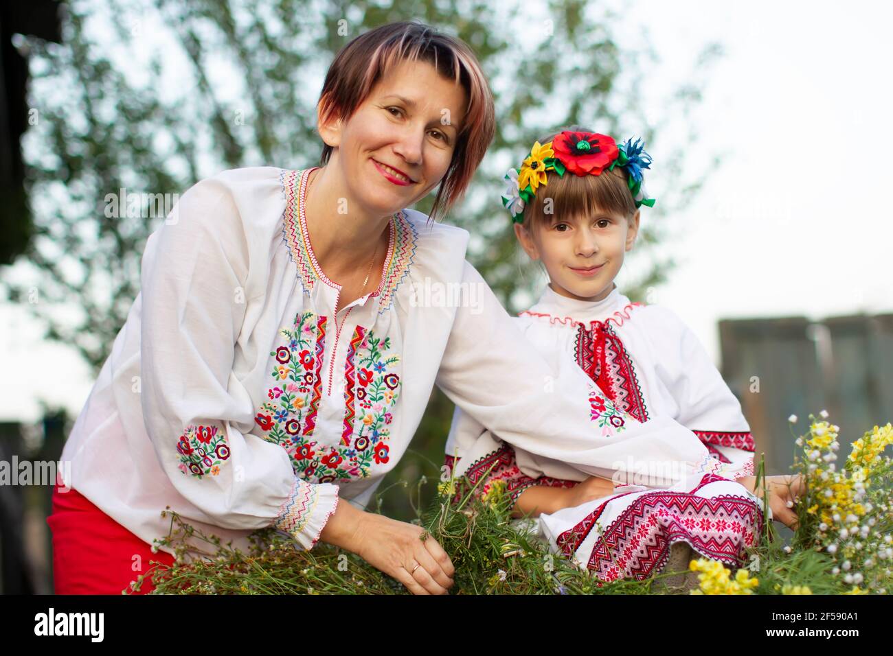 Mom and daughter in Slavic national clothes. Ukrainian or Belarusian ... Mom and daughter in Slavic national clothes. Ukrainian or Belarusian ...