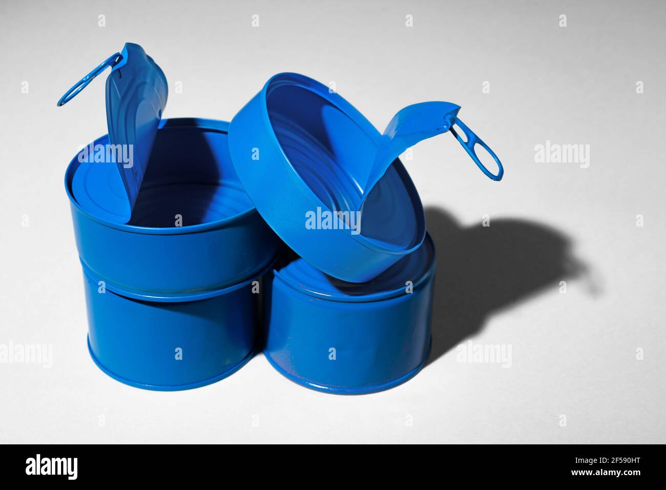 Blue tin can on gray background with shadow Stock Photo - Alamy