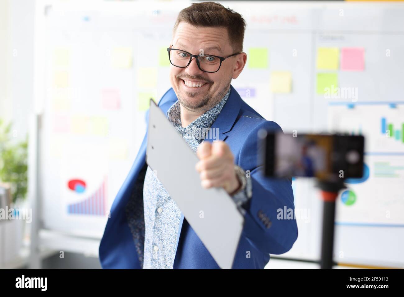 Coach pointing at mobile phone hi-res stock photography and images - Alamy