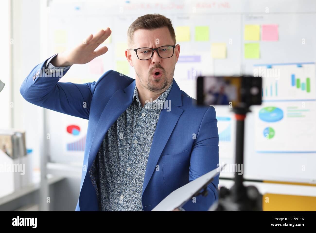 Business coach telling information into mobile phone camera Stock Photo ...
