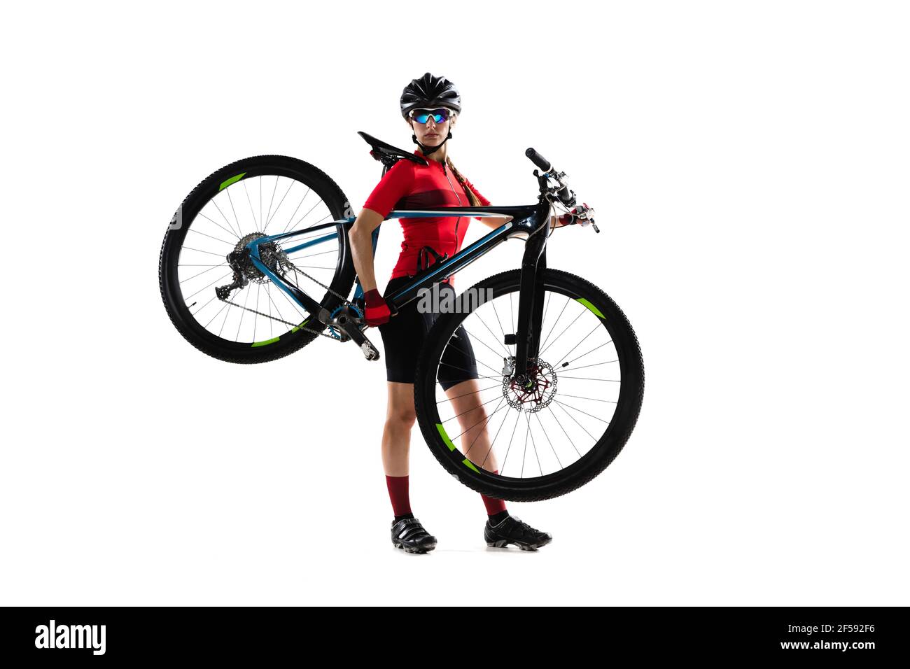 Young professional female cyclist with sport bike isolated on white ...