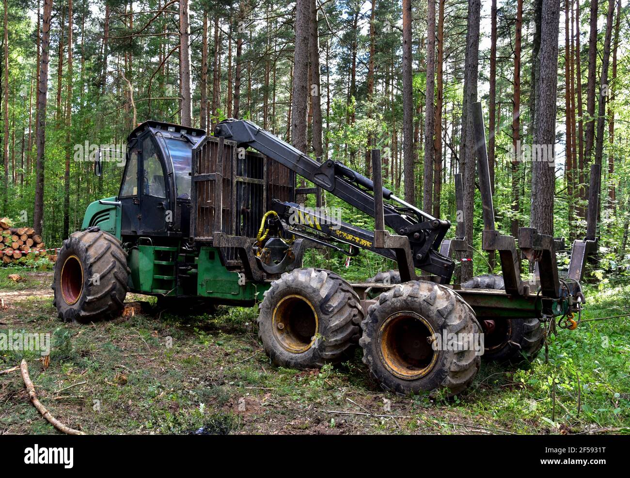 Crane forwarder machine at during clearing of a plantation. Wheeled ...