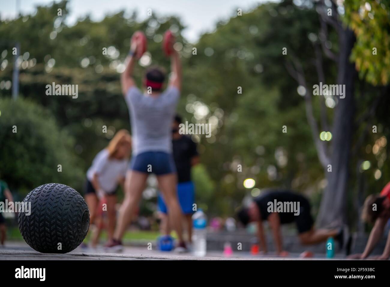 Group of people working out in a park with weightlifting equipment on a ...
