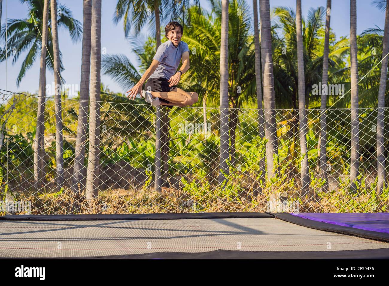 Happy man jumping on trampoline hi-res stock photography and images - Alamy