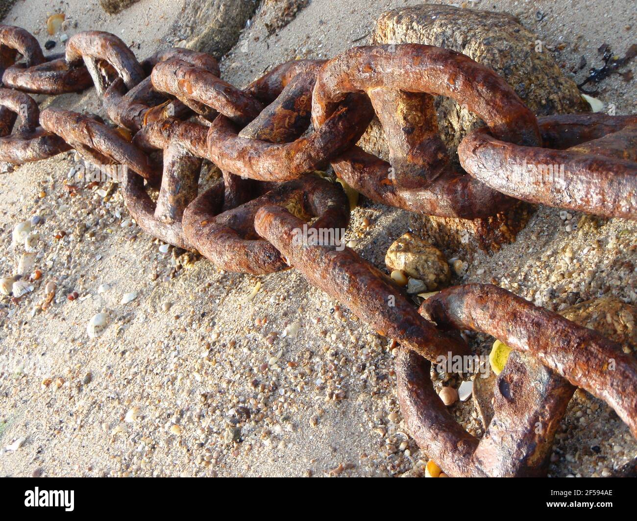 Large rusty pair of chains on beach Stock Photo - Alamy